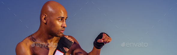 Professional kickboxer is training and practicing punch on studio ...