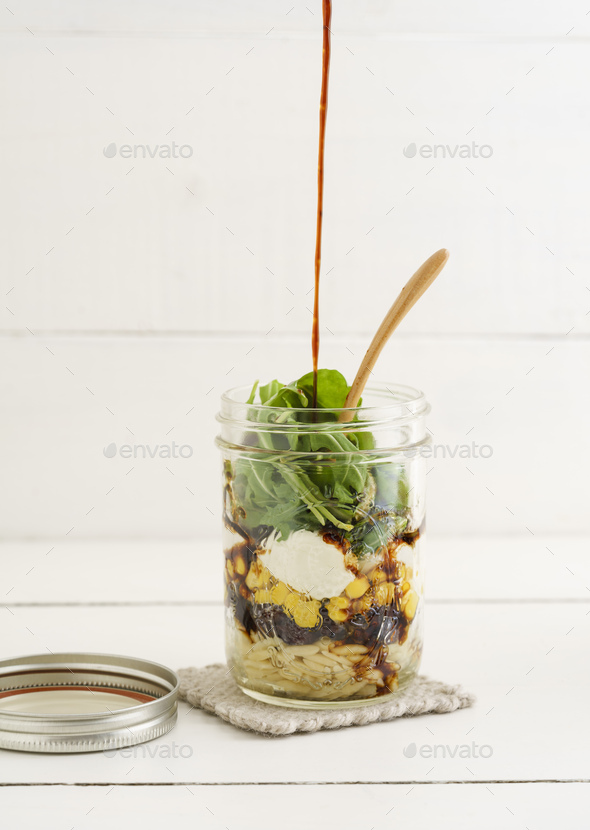 Jar of vegetarian mixed salad with Kritharaki, corn, rocket and ...