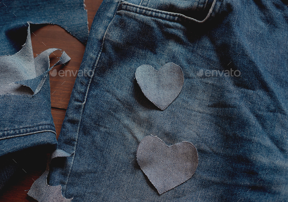 Upcycle old denim garbage. Recycling old jeans. Stack of old blue jeans ...