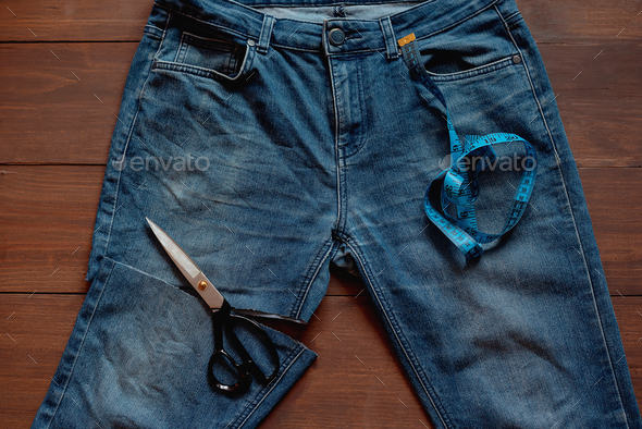 Upcycle old denim garbage. Recycling old jeans. Stack of old blue jeans ...