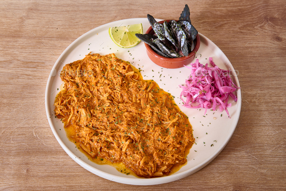 dish of shredded meat, pickled onion, nachos and lime. Typical Mexican ...