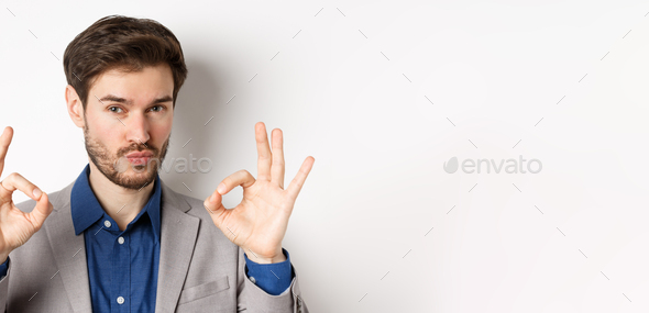 Not bad. Impressed caucasian businessman nod in approval, showing okay ...