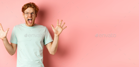 Angry and pressured young man losing temper, spread hands sideways and ...