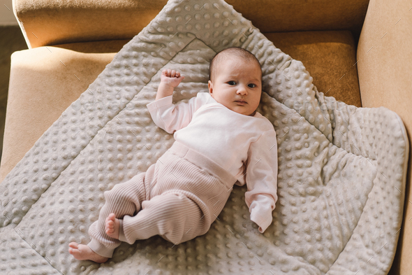 Portrait of a 1 month old baby. Cute newborn baby lying on a developing ...