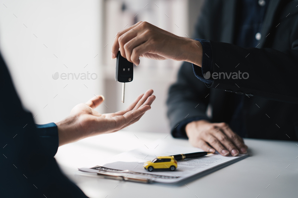 Business car rental, sell or buy service, salesman giving auto key of ...