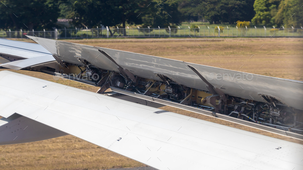 Wing braking of the aircraft on the runway. Stock Photo by kckate16