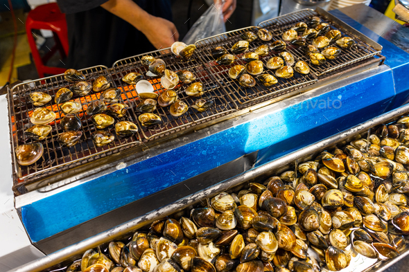 Grill seafood clam on metal net in street market of Taiwan Stock Photo ...