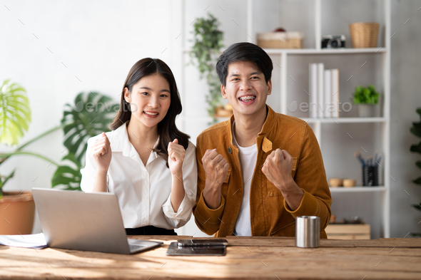Photo of cheerful loving young couple using laptop computer and ...