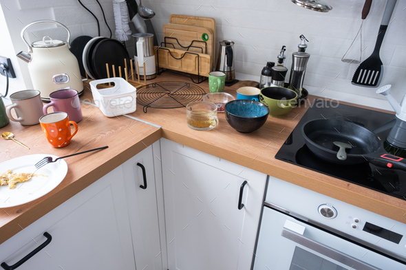 A mess in the kitchen, dirty dishes on the table, scattered things ...