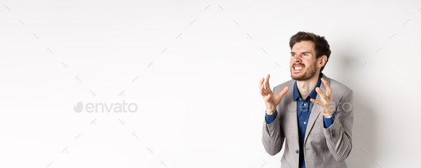 Angry man in business suit look left with hatred, stare aside and ...