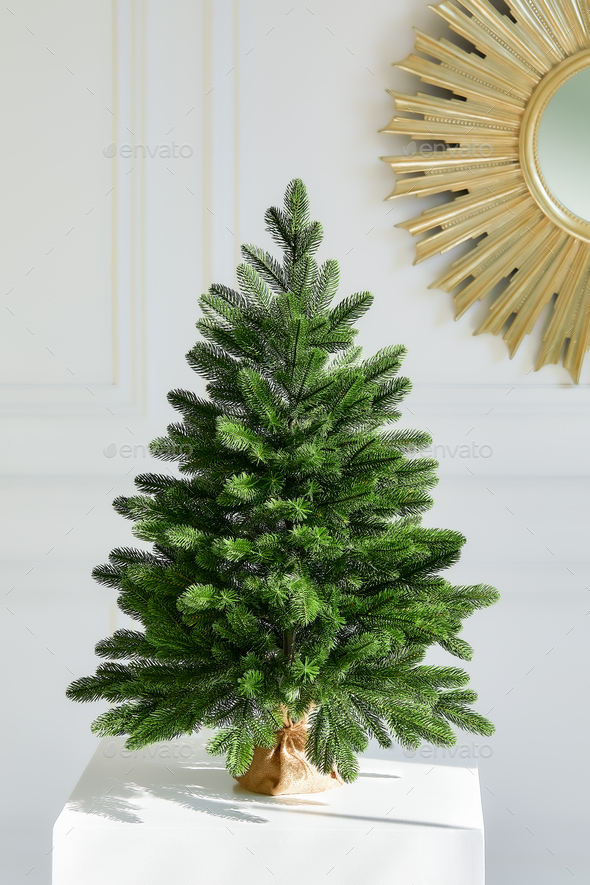 Artificial Christmas green tree without decorations on a metal stand ...