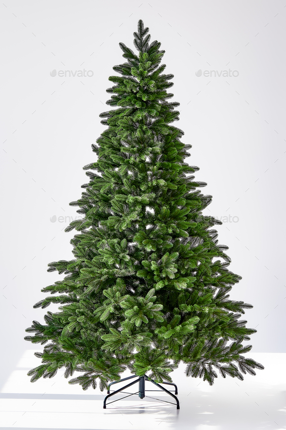 Artificial Christmas green tree without decorations on a metal stand ...