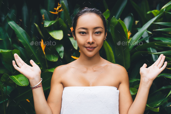 charming female model with raised hands posing outdoors - cosmetology ...