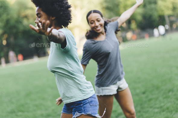 Two best friends having fun together in the park at evening Stock Photo ...