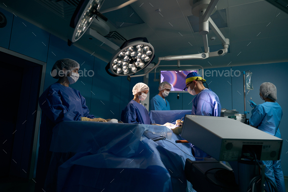 Teamwork of a surgeon, anesthetist and assistants in operating room ...