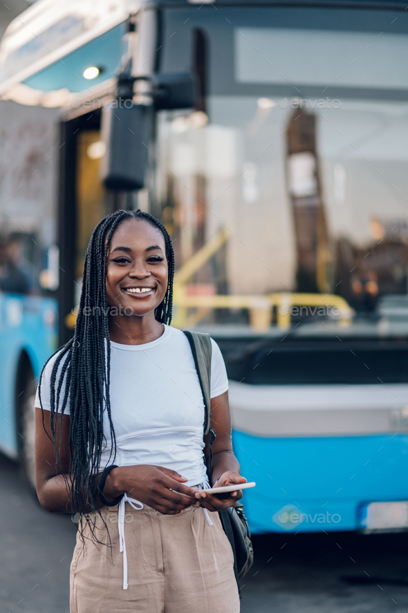 Portrait of an african american woman waiting public transportation on ...