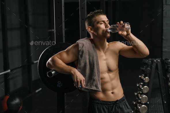 Man drinking water in a gym after hard crossfit session Stock Photo by ...