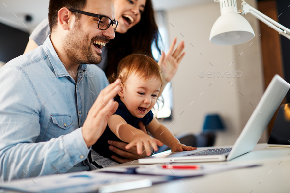 Young parents mom, dad and their toddler son have a video call via ...