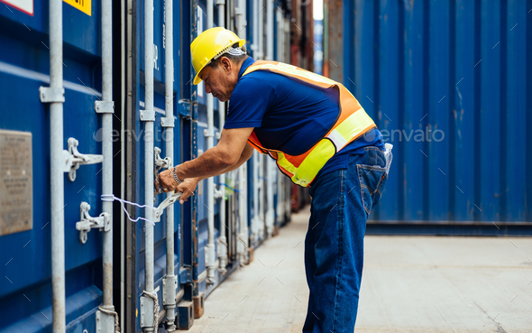 Industrial logistic worker working at overseas shipping container yard ...