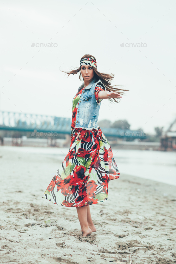 Beautiful hippie woman posing barefoot in the sand by the river Stock ...