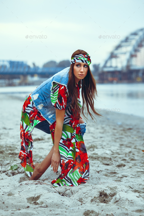 Beautiful hippie woman posing barefoot in the sand by the river Stock ...