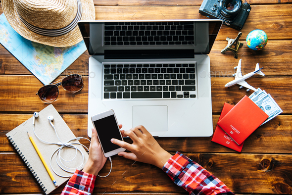 Travelers are planning a trip by searching the route on the map and ...