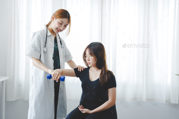 Physical therapist giving dumbbell exercises about the arms and ...
