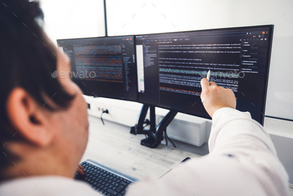 Close up over the shoulder view unrecognizable man, programmer coding ...