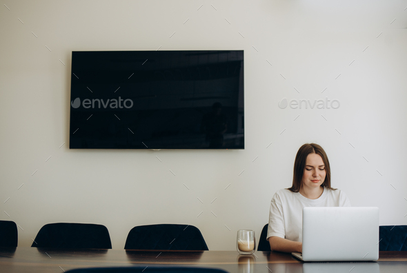 happy young girl work on laptop computer at modern home livingroom ...