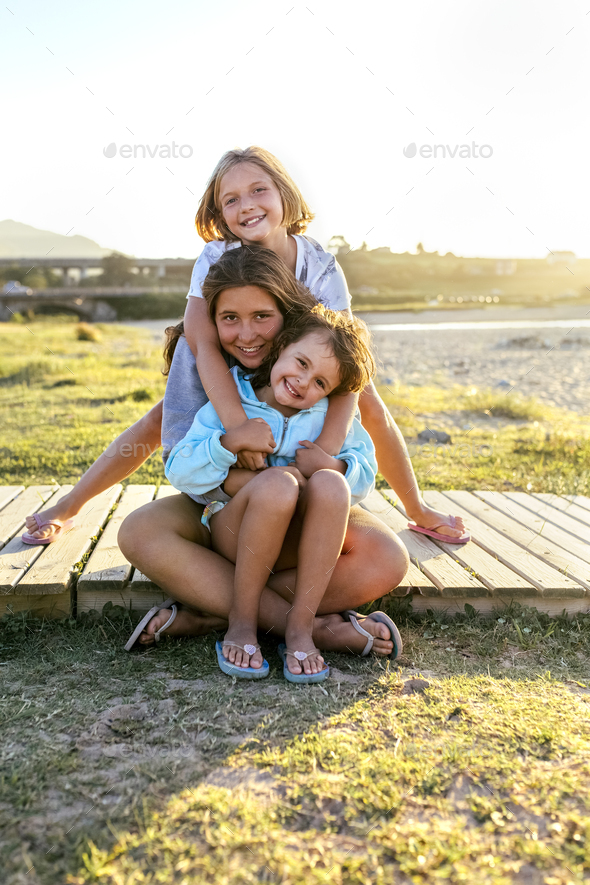 Group picture of three happy girls on boardwalk Stock Photo by westend61