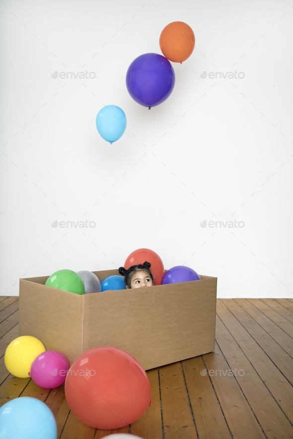 Girl inside cardboard box with balloons Stock Photo by westend61 ...