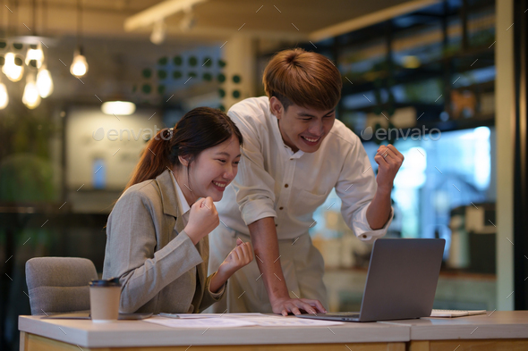 Happy two Asian business people raising their hand to congratulate ...