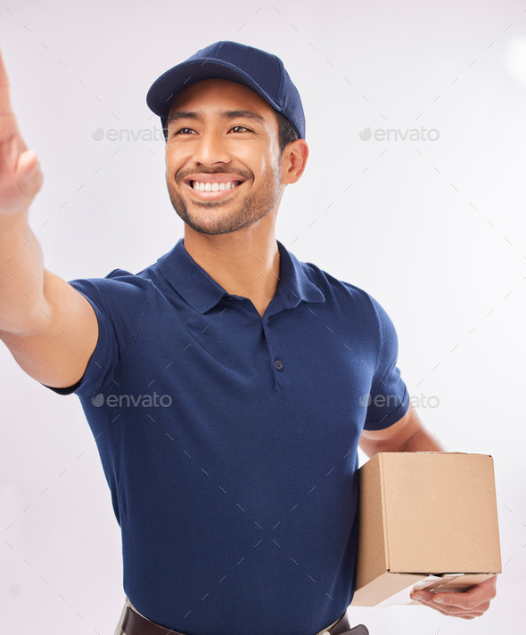 Delivery man, shipping box and smile of a employee in studio with ...