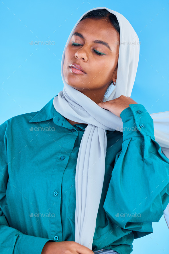Calm muslim, woman and beauty of hijab in studio, blue background or ...