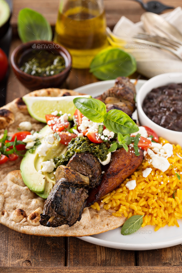 Beef kebab with rice, beans and fried plantains Stock Photo by fahrwasser