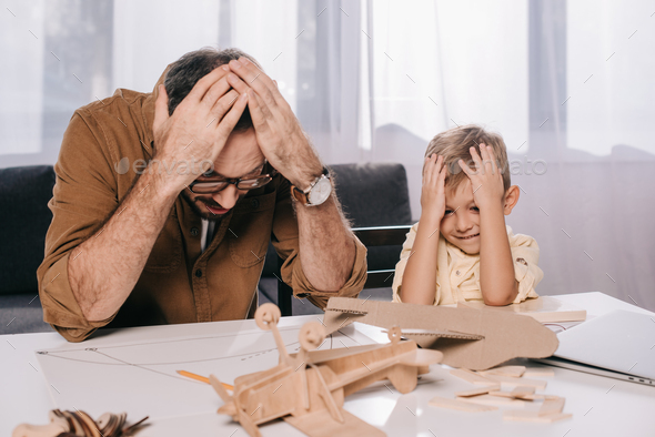 exhausted father and son modeling together at home Stock Photo by ...