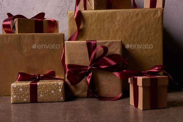 Christmas gift boxes on floor in room Stock Photo by LightFieldStudios