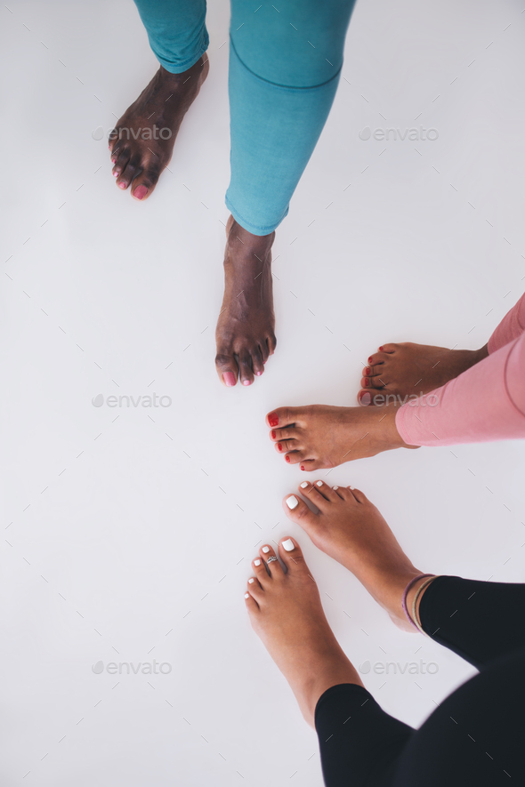 Female friends with pedicure have photo session as barefoot models in ...