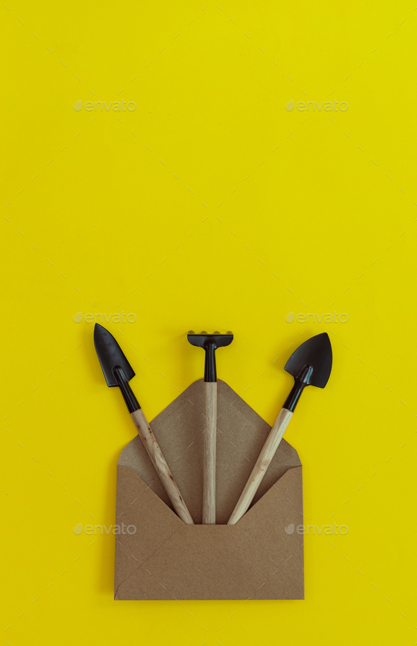 Three garden tools in a craft envelope on a yellow background. Stock ...