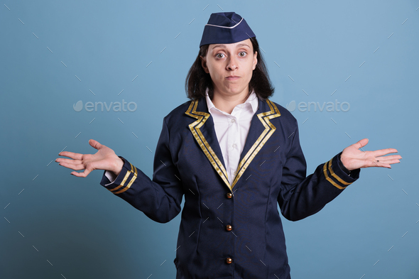 Portrait of confused flight attendant showing unsure gesture Stock ...