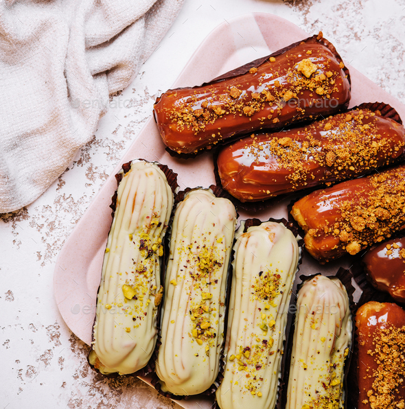 traditional french eclairs with chocolate and vanilla cream and cup of ...