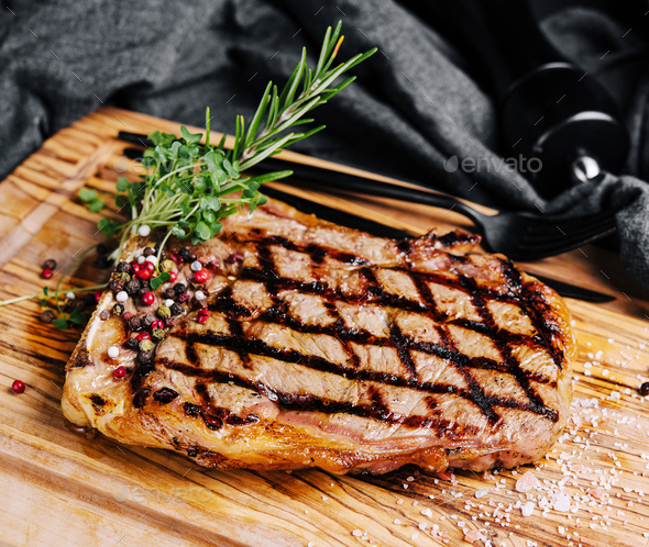 Grilled striploin sliced steak on cutting board Stock Photo by ...