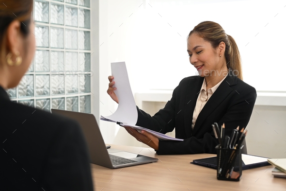 Smiling female hr manager considering application female candidate ...