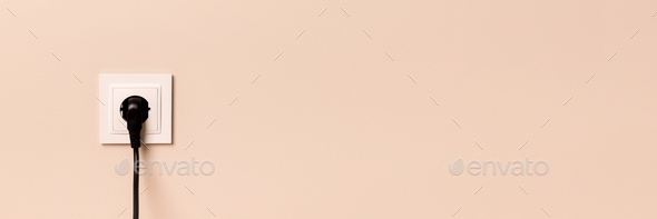 Electrical outlet with plug on beige wall banner, header Stock Photo by ...