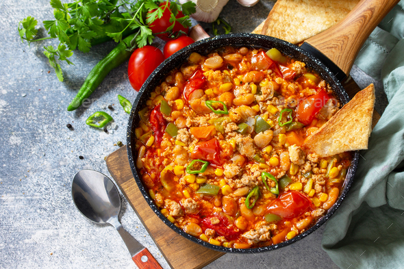 Chili con carne from meat, beans and vegetables on dark stone table ...