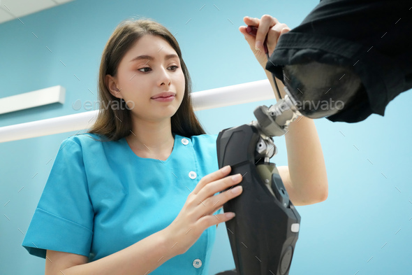 Orthopedic technician adjusting mechanism on prosthetic leg for ...