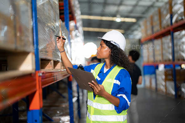 Female warehouse worker arranging of product in cardboard box in shelf ...