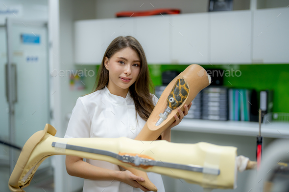 Orthopedic technician adjusting prosthetic leg for disabilities people ...