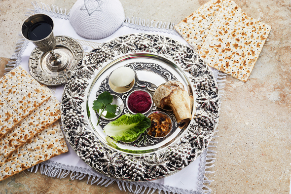 Composition with symbolic Passover, Pesach, items and meal on stone ...