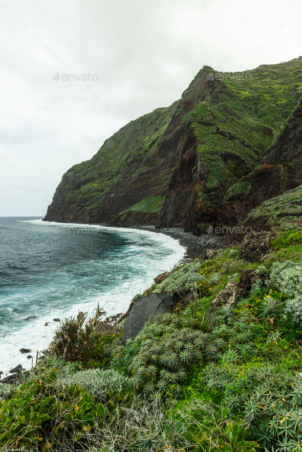 Volcanic beach and cliffs in Madeira Island. Atlantic ocean waves and ...